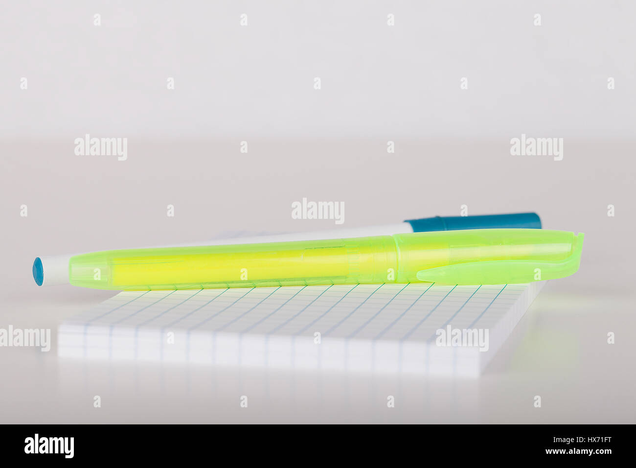 Pen and yellow marker on a notepad isolated on white background Stock ...