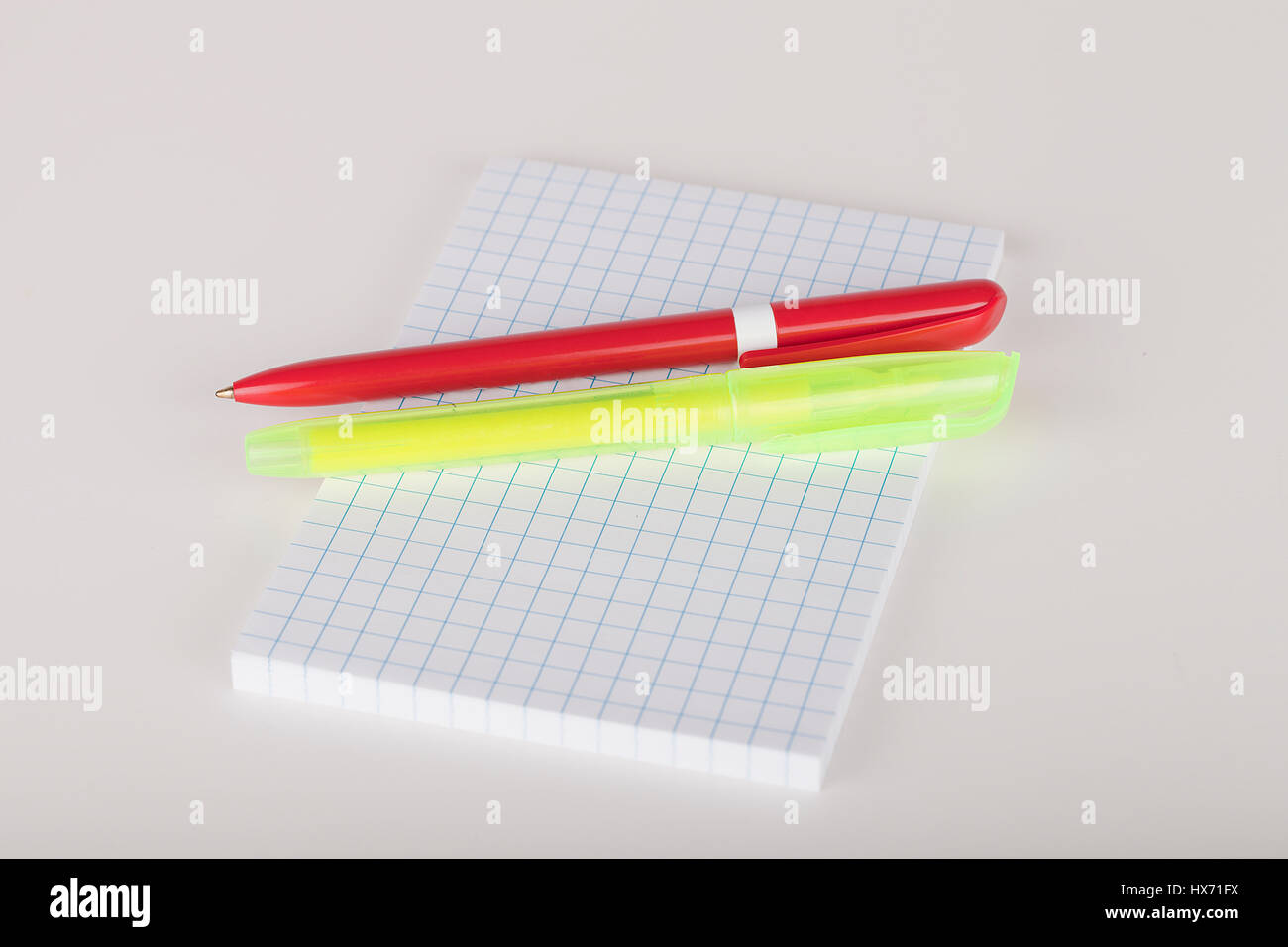 Pen and yellow marker on a notepad isolated on white background Stock ...