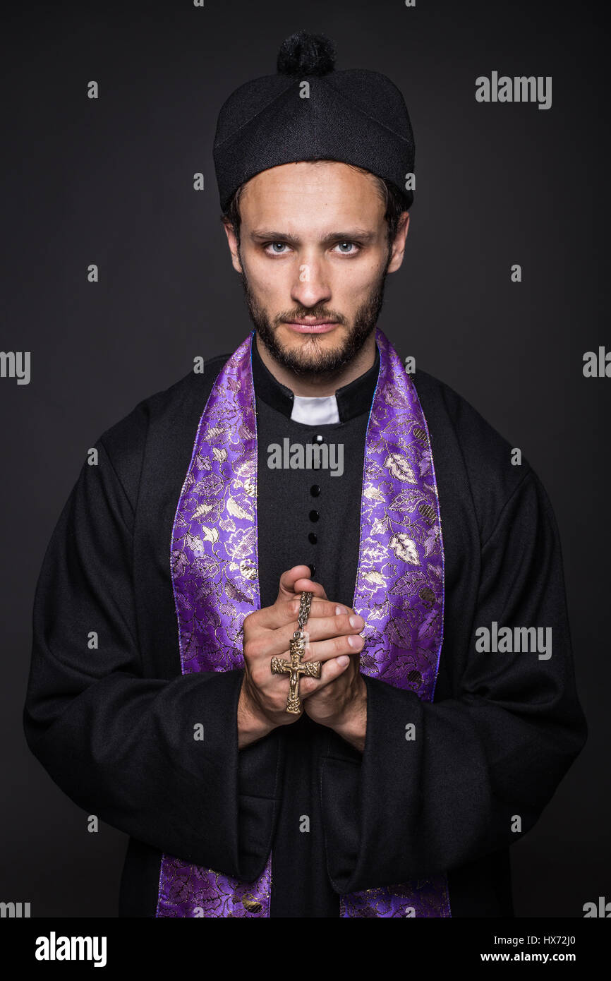 Portrait of young priest. Studio portrait on black background Stock ...