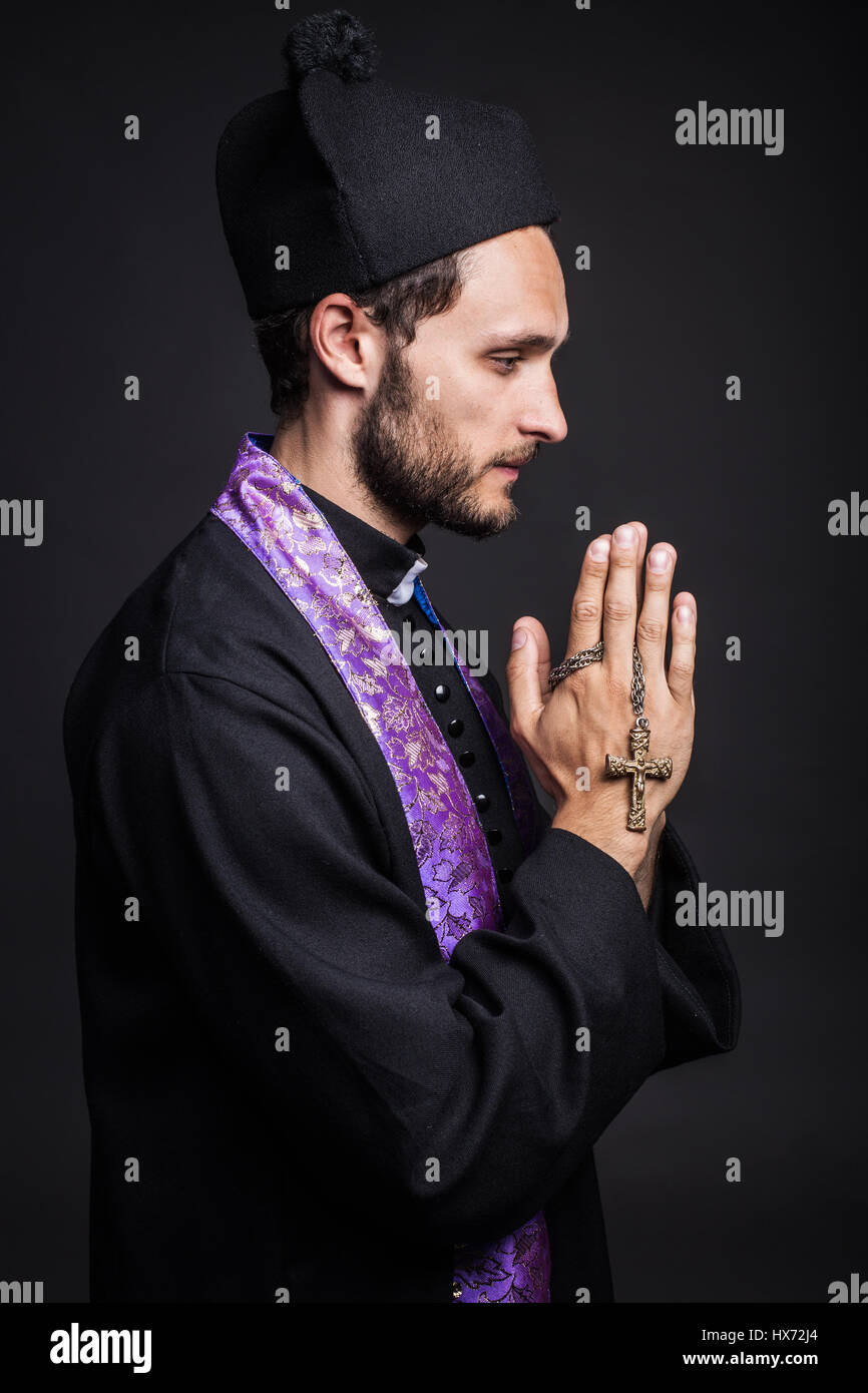 Portrait of young priest. Studio portrait on black background Stock ...