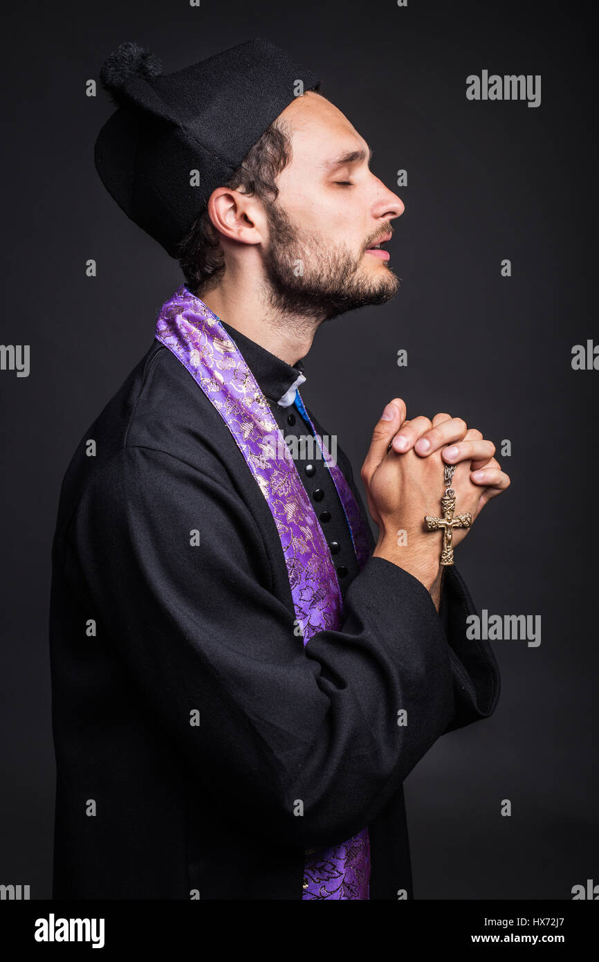 Portrait of young priest. Studio portrait on black background Stock ...
