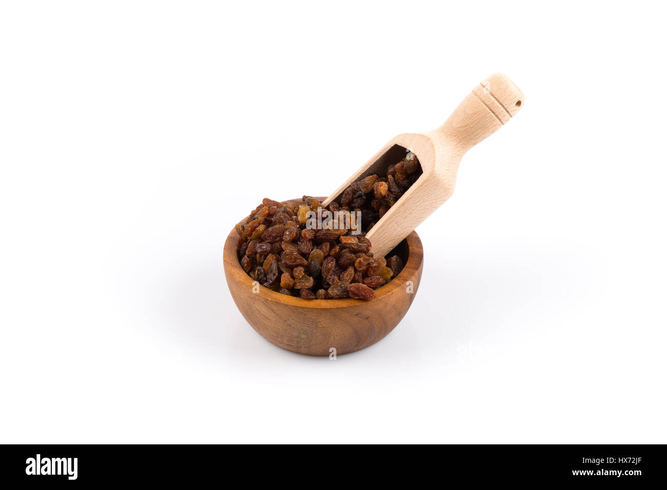 Sweet dry raisins in bowl and scoop isolated on the white background ...