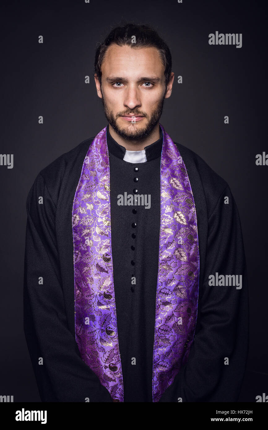 Portrait of young priest. Studio portrait on black background Stock ...