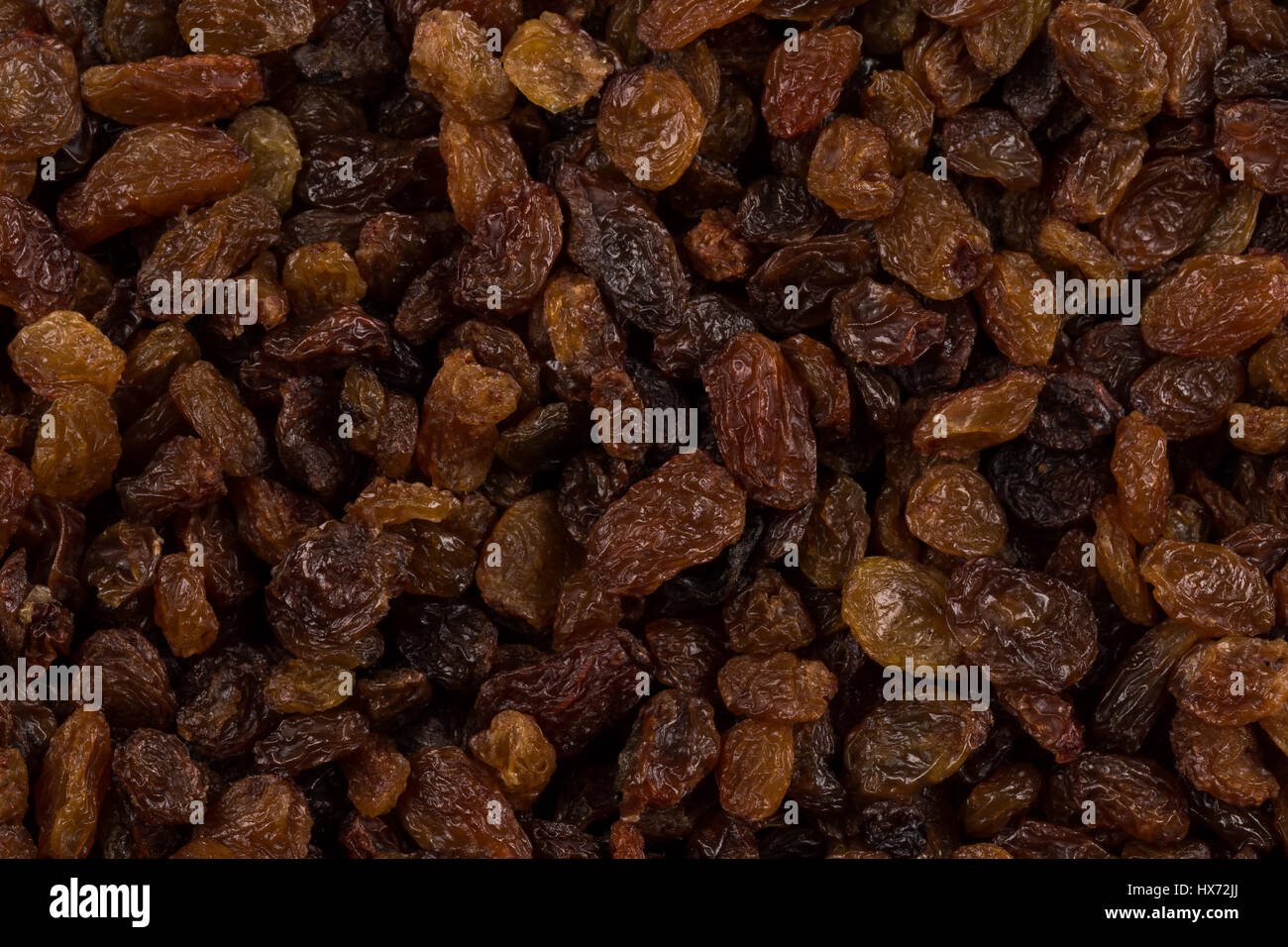 Sweet dry raisins close up shot for background Stock Photo - Alamy
