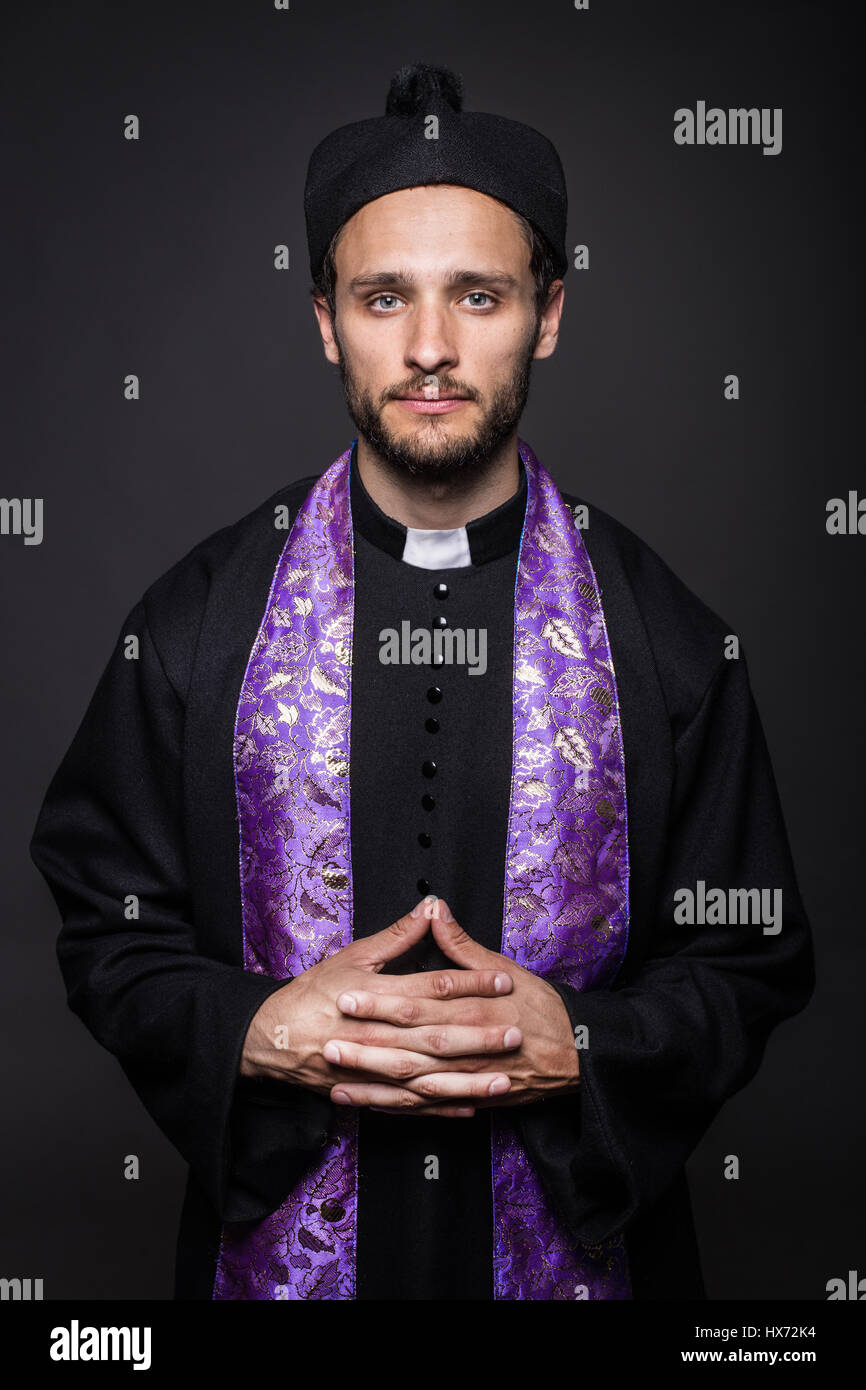 Portrait of young priest. Studio portrait on black background Stock ...