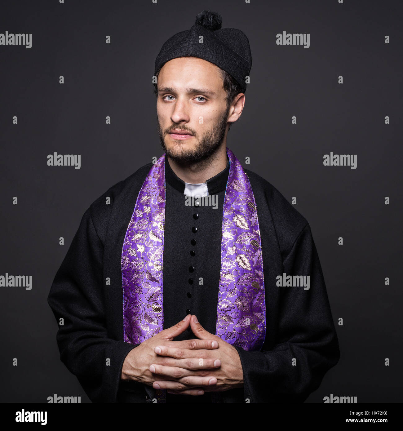 Portrait of young priest. Studio portrait on black background Stock ...