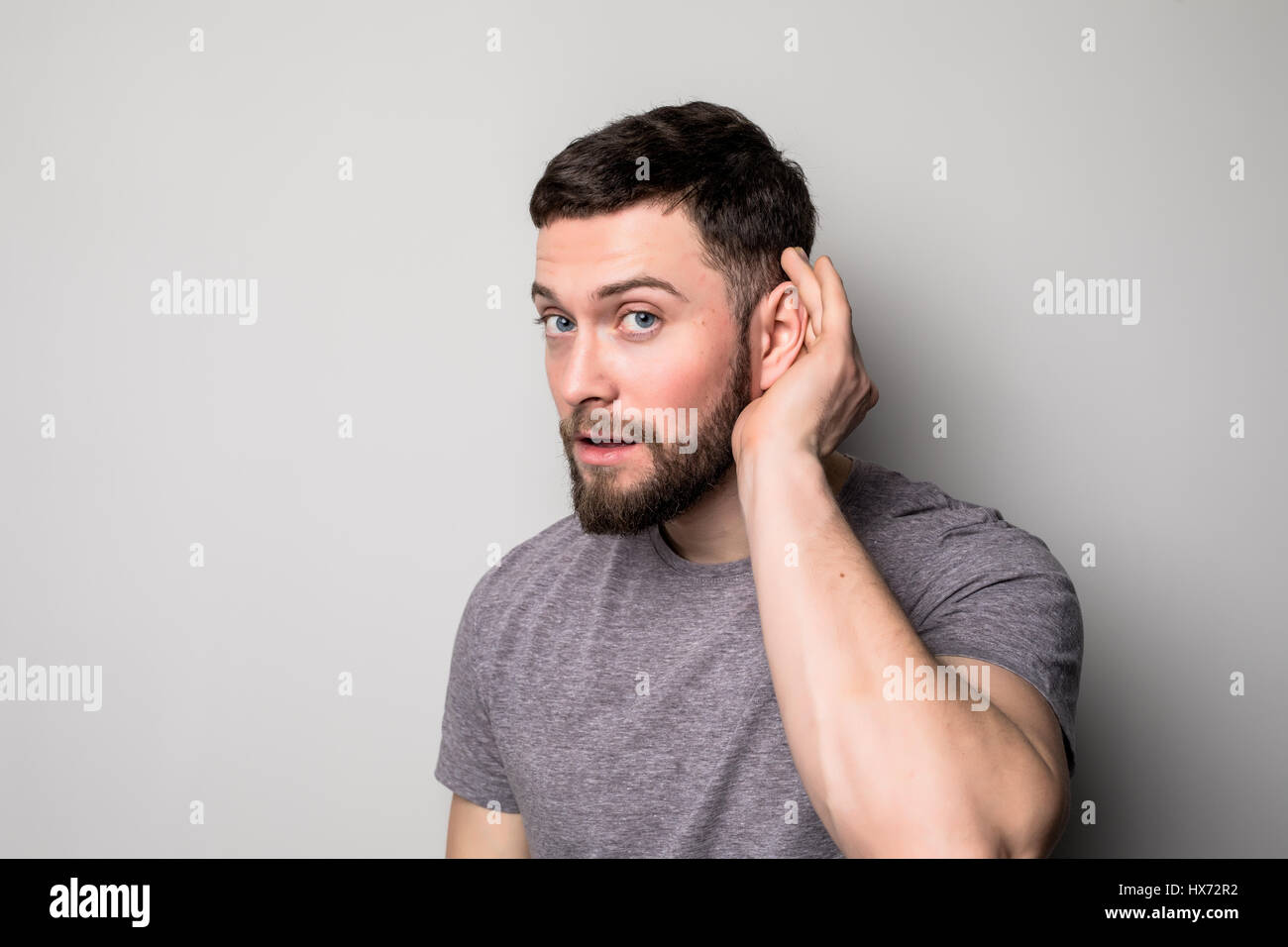 Closeup portrait a man placing hand on ear listening carefully to ...
