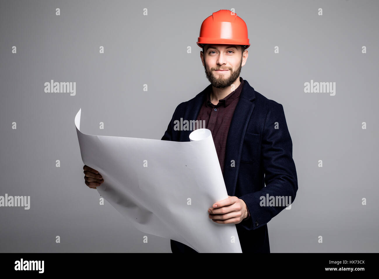 Portrait of an architect builder studying layout plan of the rooms ...