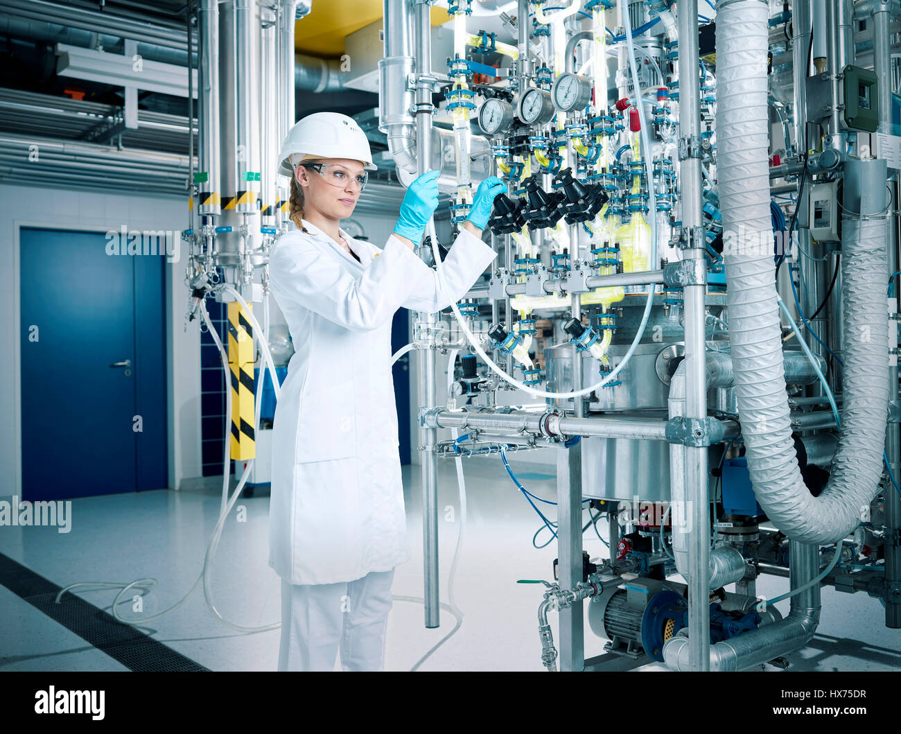 Chemielaborantin, chemist with helmet and goggles in a pharmaceutical ...