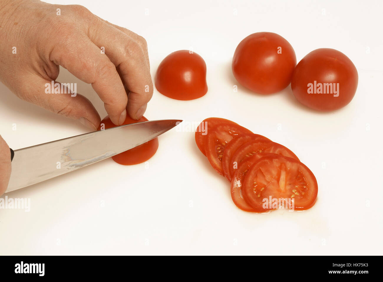 A chef slicing tomatoes Stock Photo - Alamy