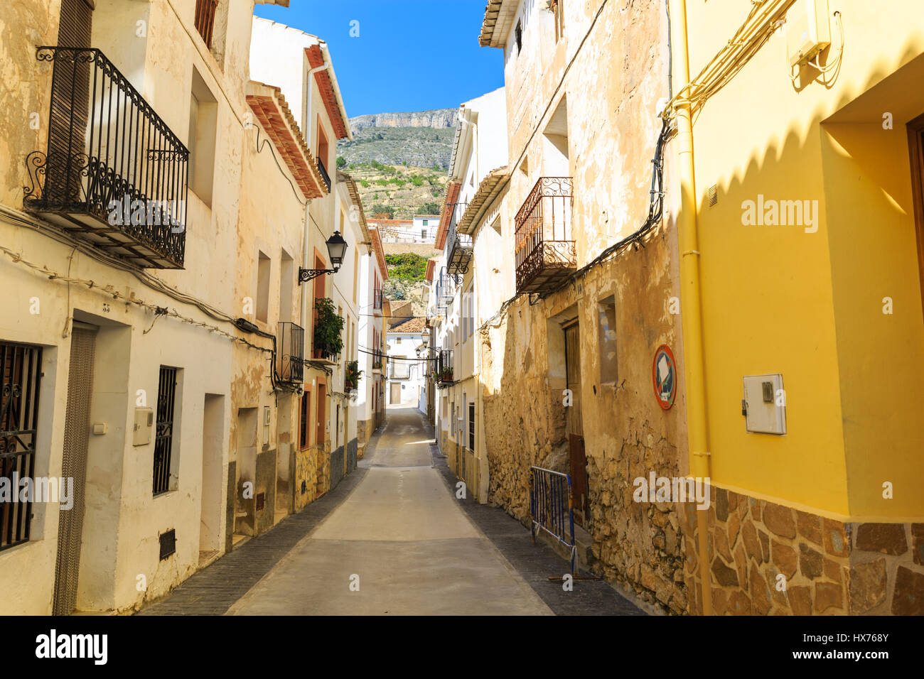 Typical narrow Spanish street in the mountain village of Sella, Costa ...