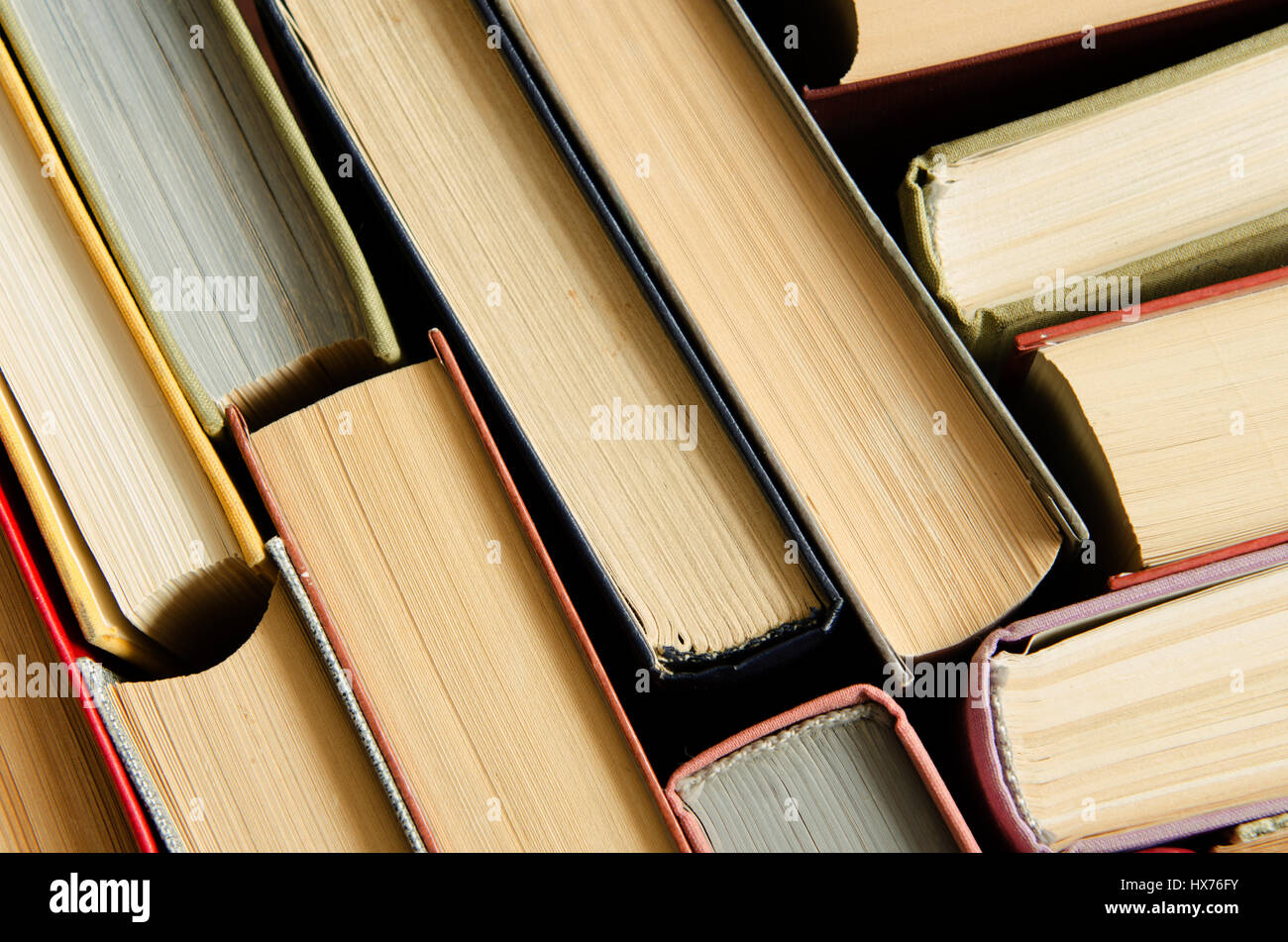 a stack of colorful books in a library or a room Stock Photo - Alamy