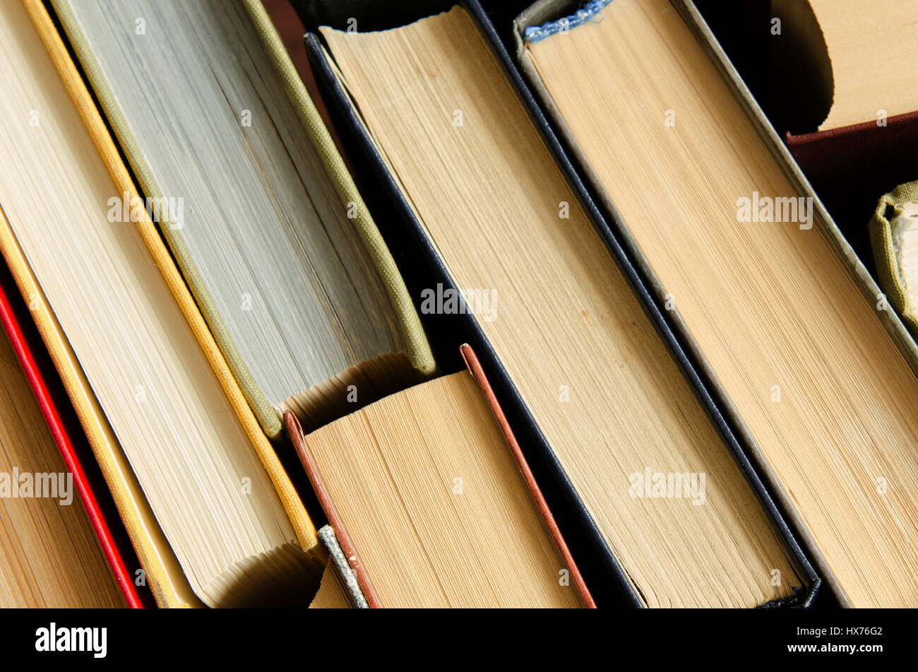 a stack of colorful books in a library or a room Stock Photo - Alamy