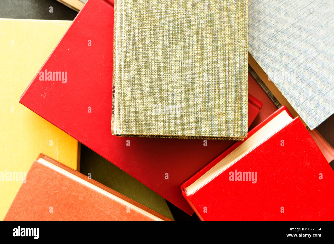 a stack of colorful books in a library or a room Stock Photo - Alamy