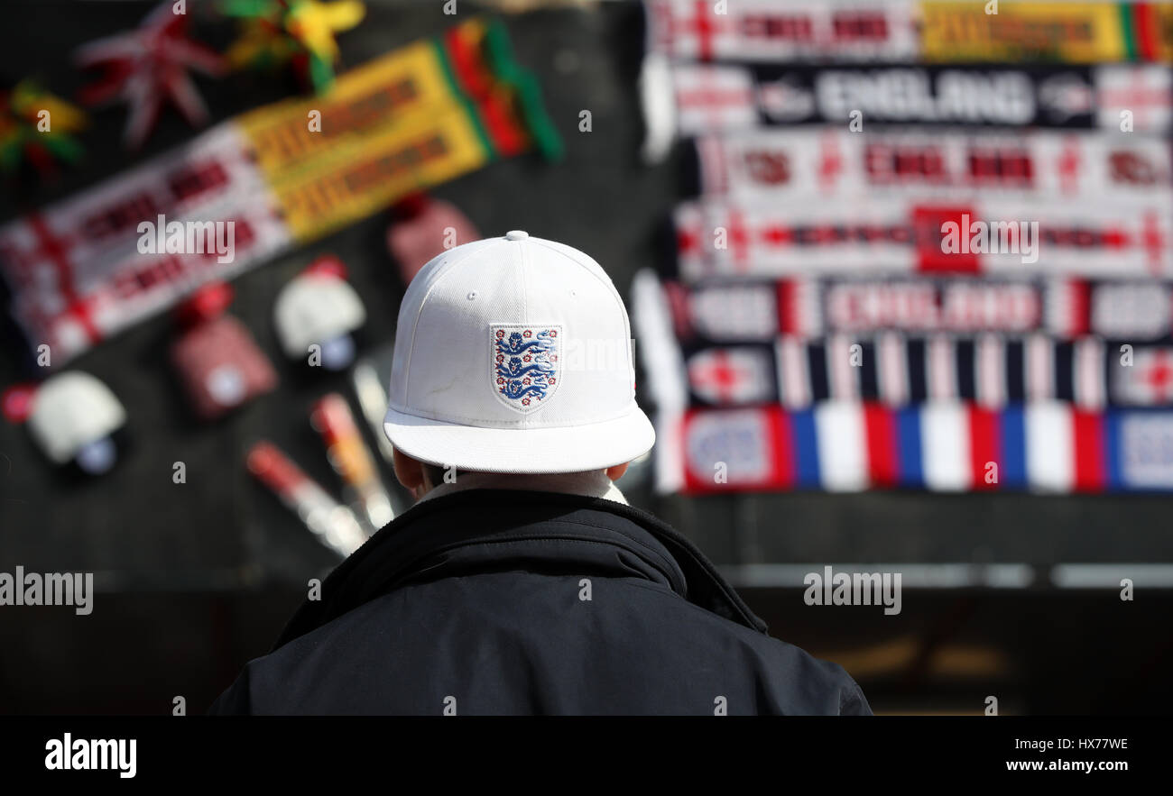 An England fan looks at merchandise for sale before the World Cup ...