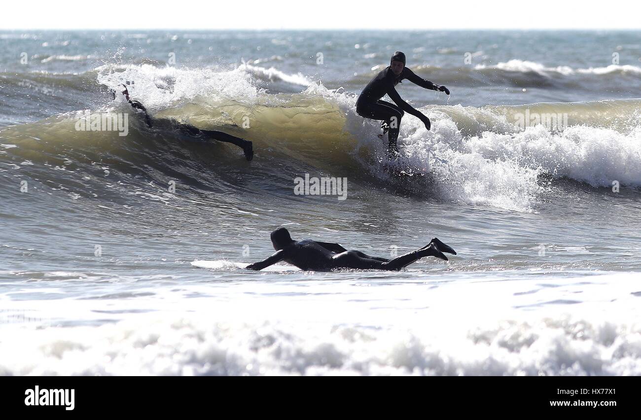 Surfers enjoy the strong waves on Bournemouth Beach in Dorset Stock ...