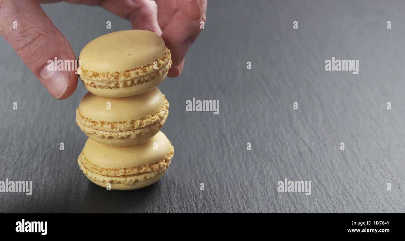man hand stacking yellow lemon macarons on slate board, 4k photo Stock ...