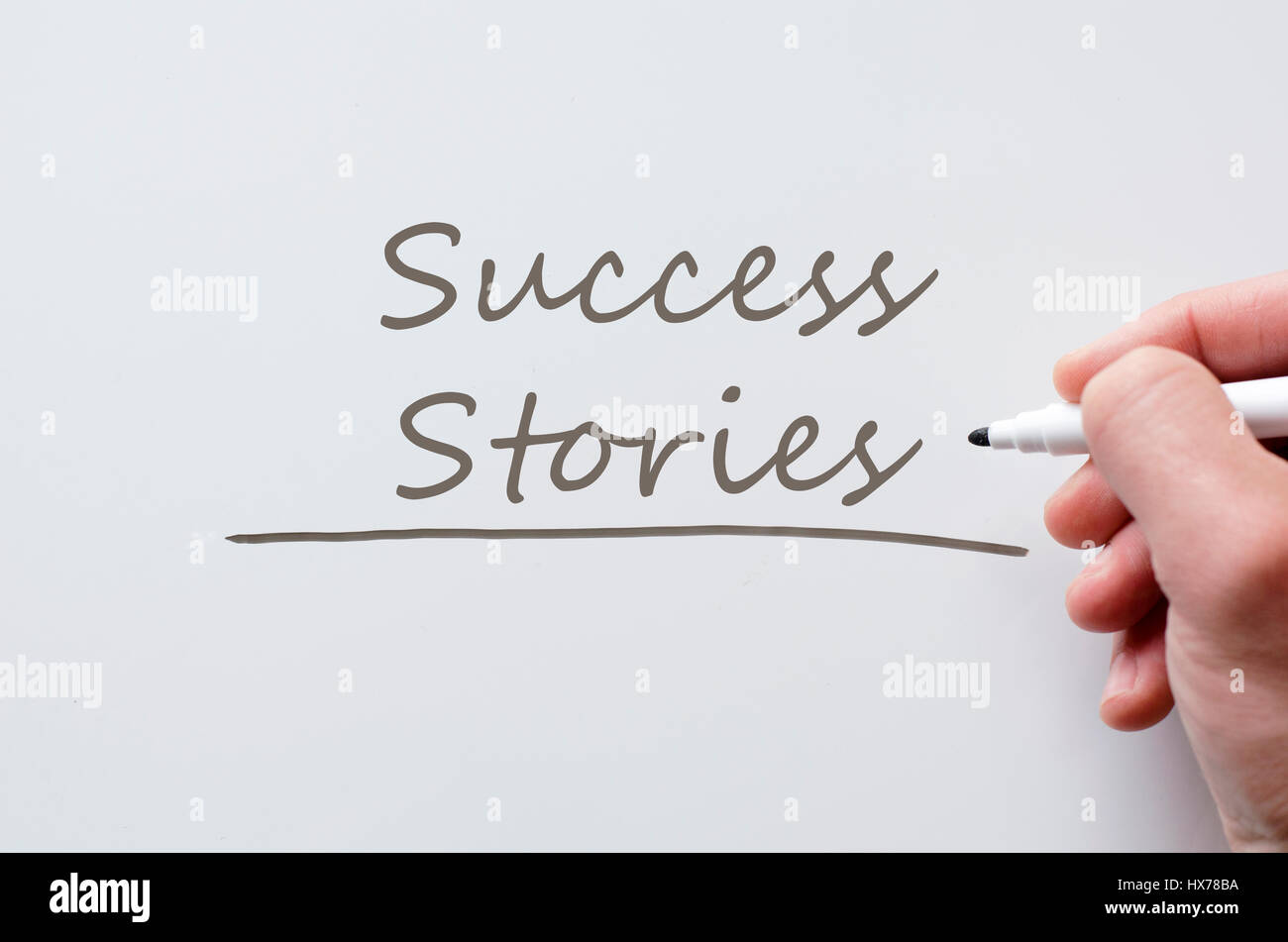 Human hand writing success stories on whiteboard Stock Photo - Alamy