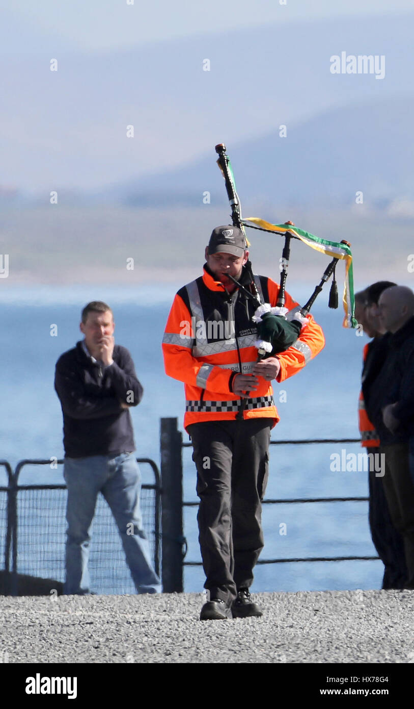 A piper plays as the body of Captain Mark Duffy is driven in a hearse ...