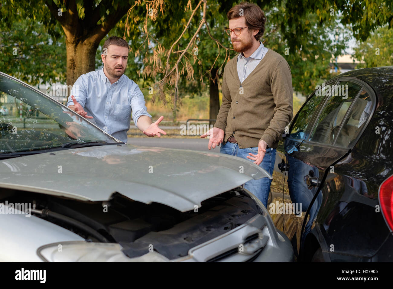 Two men arguing after a car accident on the road Stock Photo - Alamy