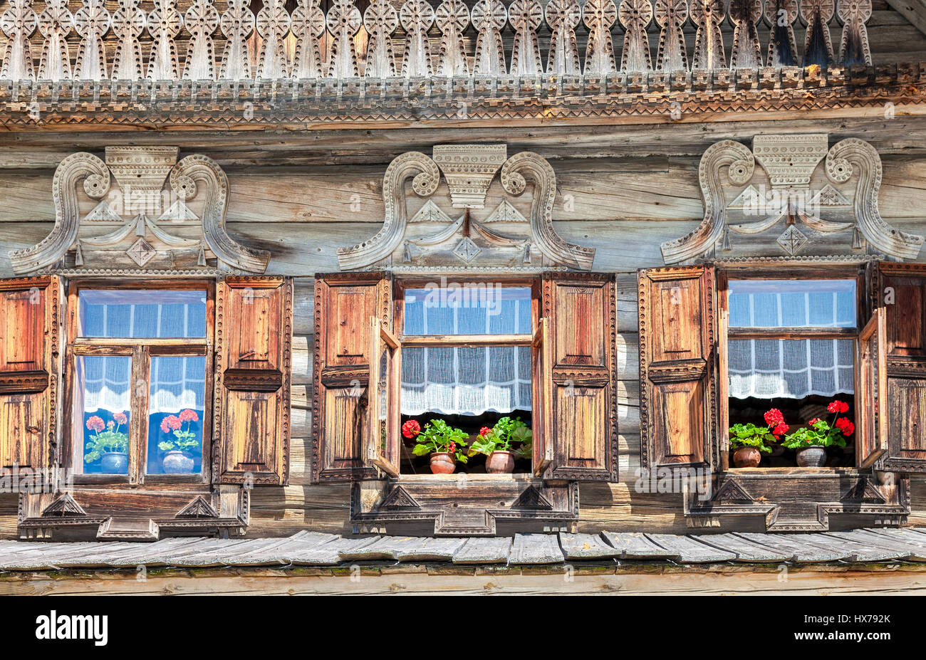 Windows of old traditional Russian log house with carved wooden trim ...