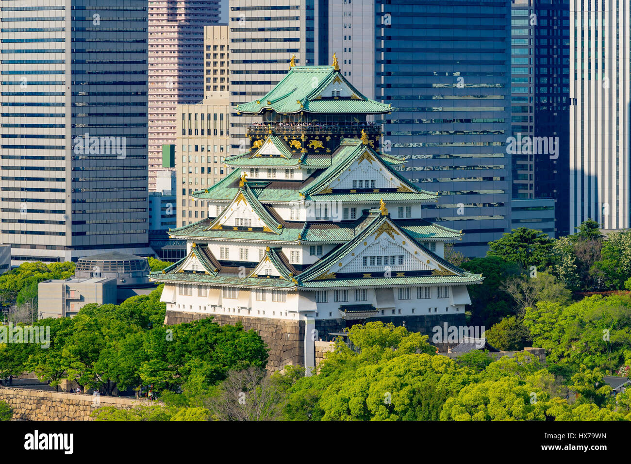 Osaka castle shot against modern buildings at sunset Stock Photo - Alamy