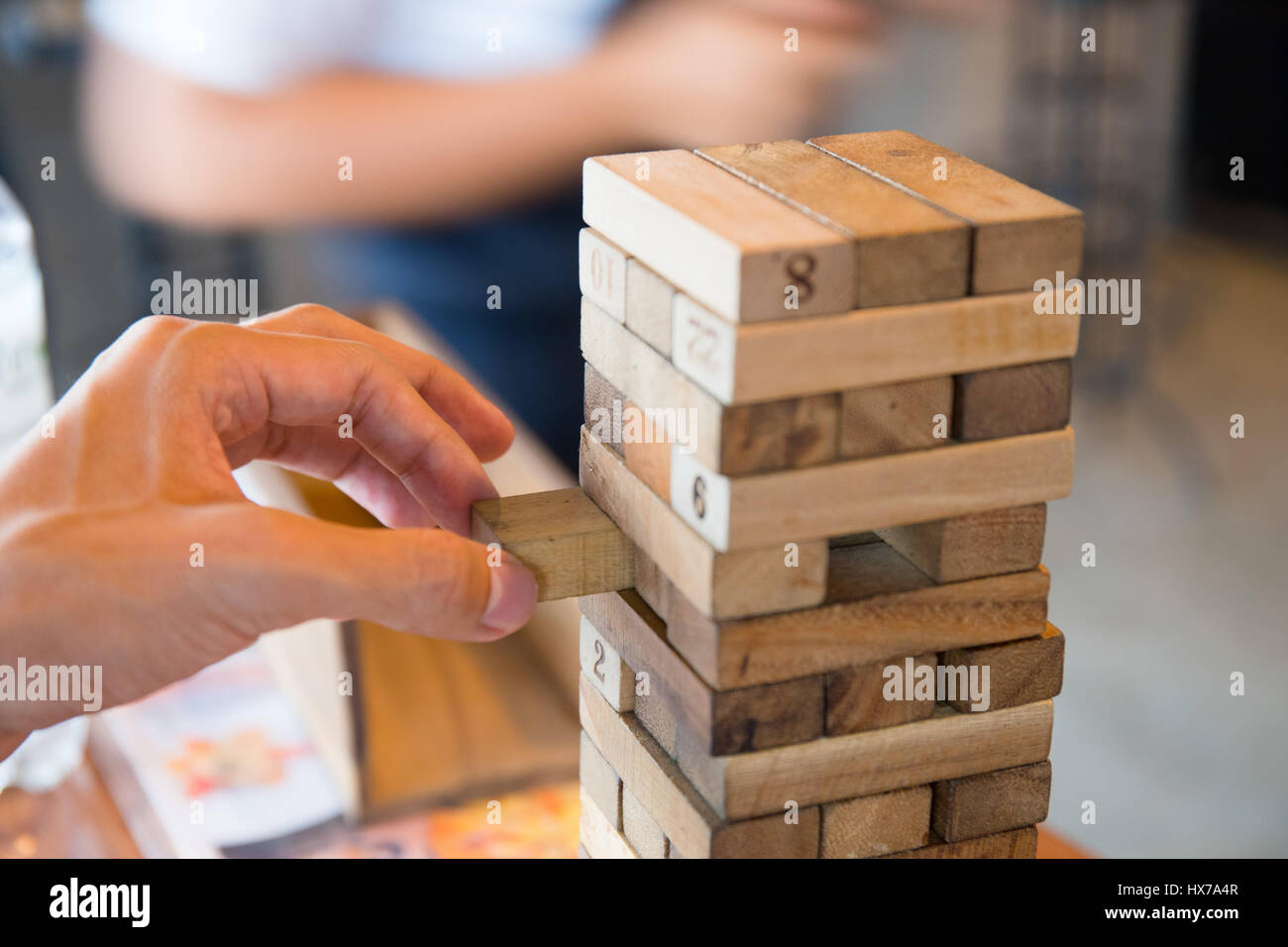 Jenga being played by an asian man Stock Photo - Alamy