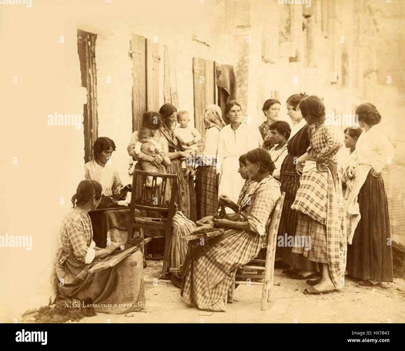 This historical photograph captures Italian women working in rural or ...