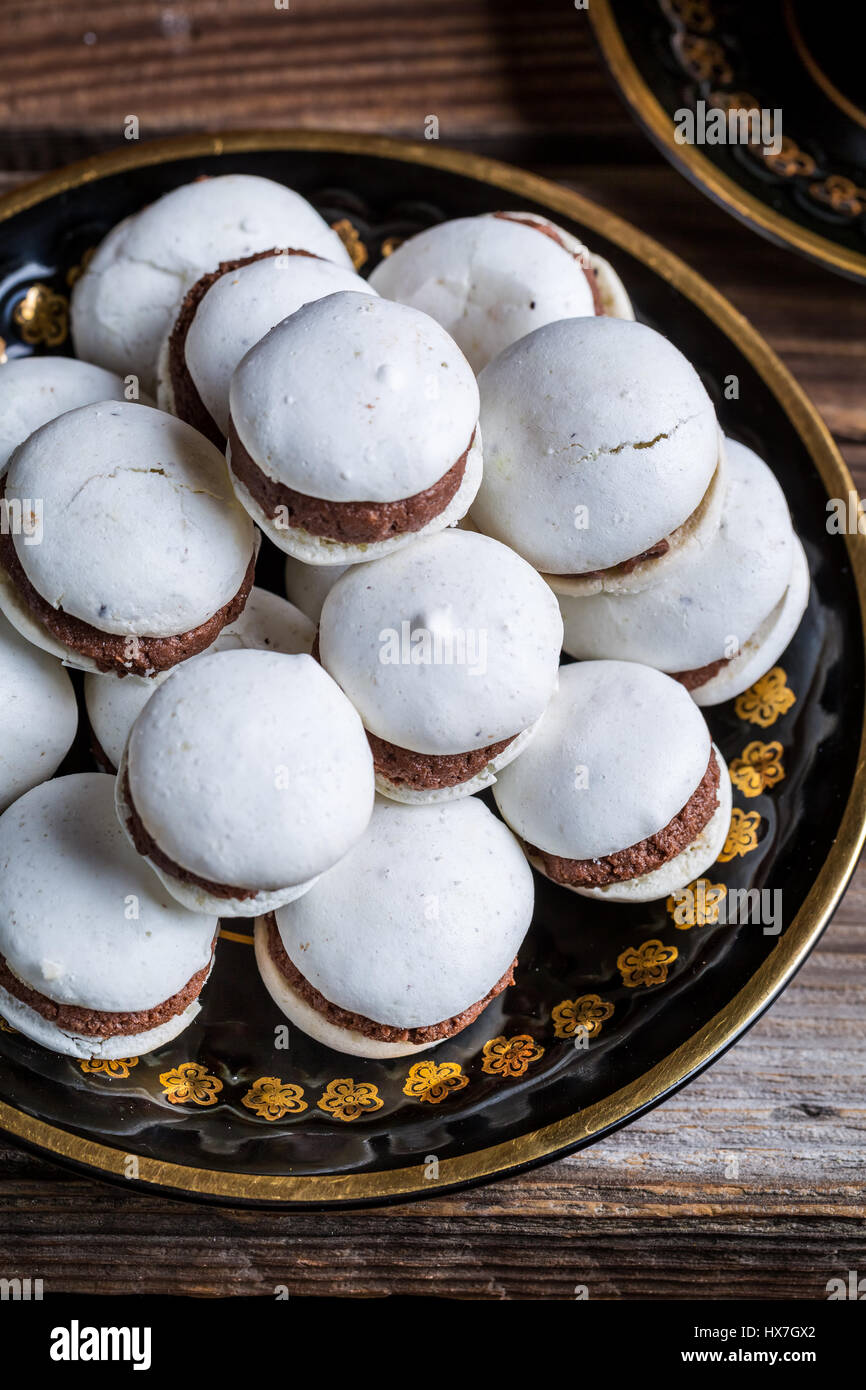 Macaroons made from white meringue and walnut stuffing Stock Photo - Alamy