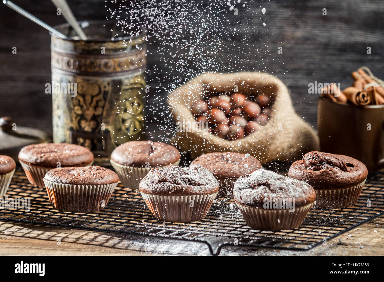 Falling icing sugar on fresh chocolate muffins Stock Photo - Alamy