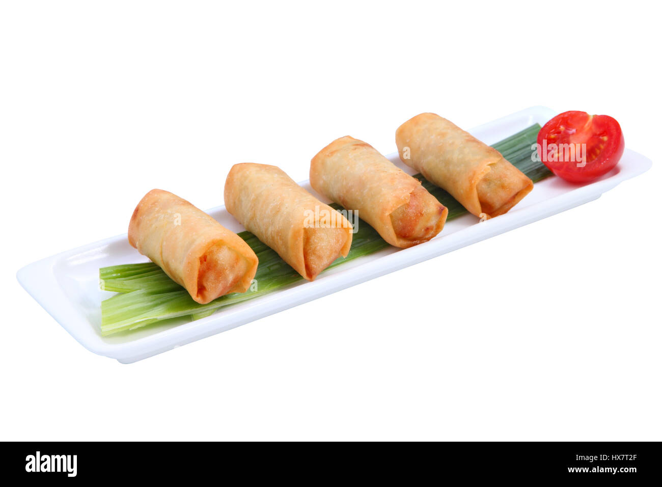 Four fried Chinese spring rolls in a row on a white, long, narrow ...
