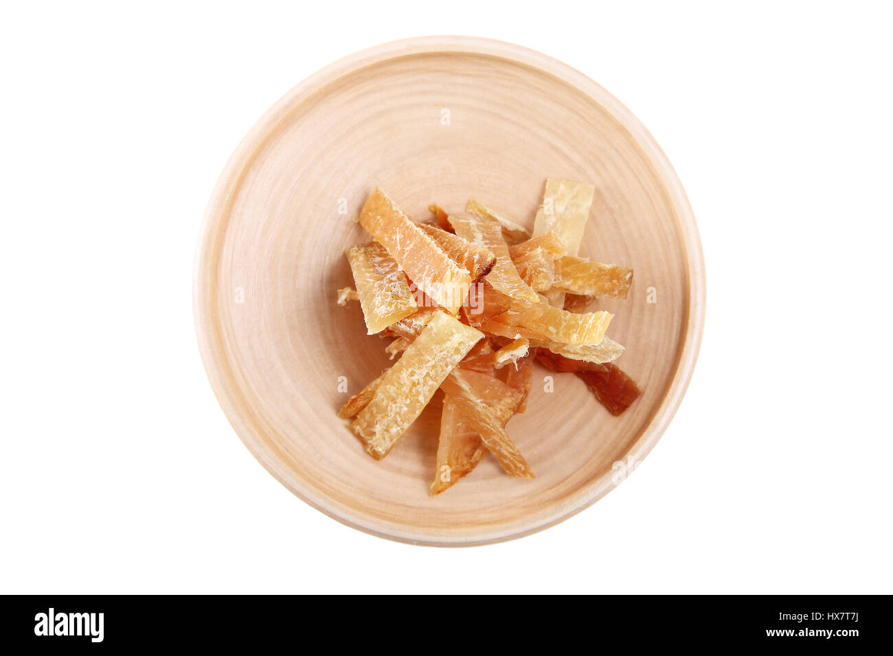 Dried fish fillets cut into strips, lay on a wooden platter. Wooden ...