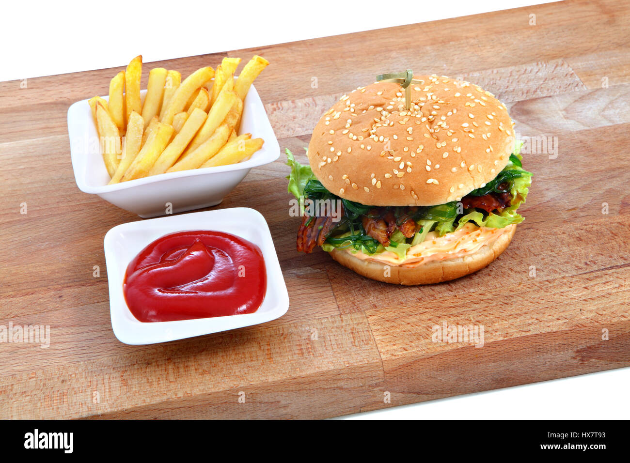 Fish burger, sandwich with smoked eel on a cutting board with slices of ...