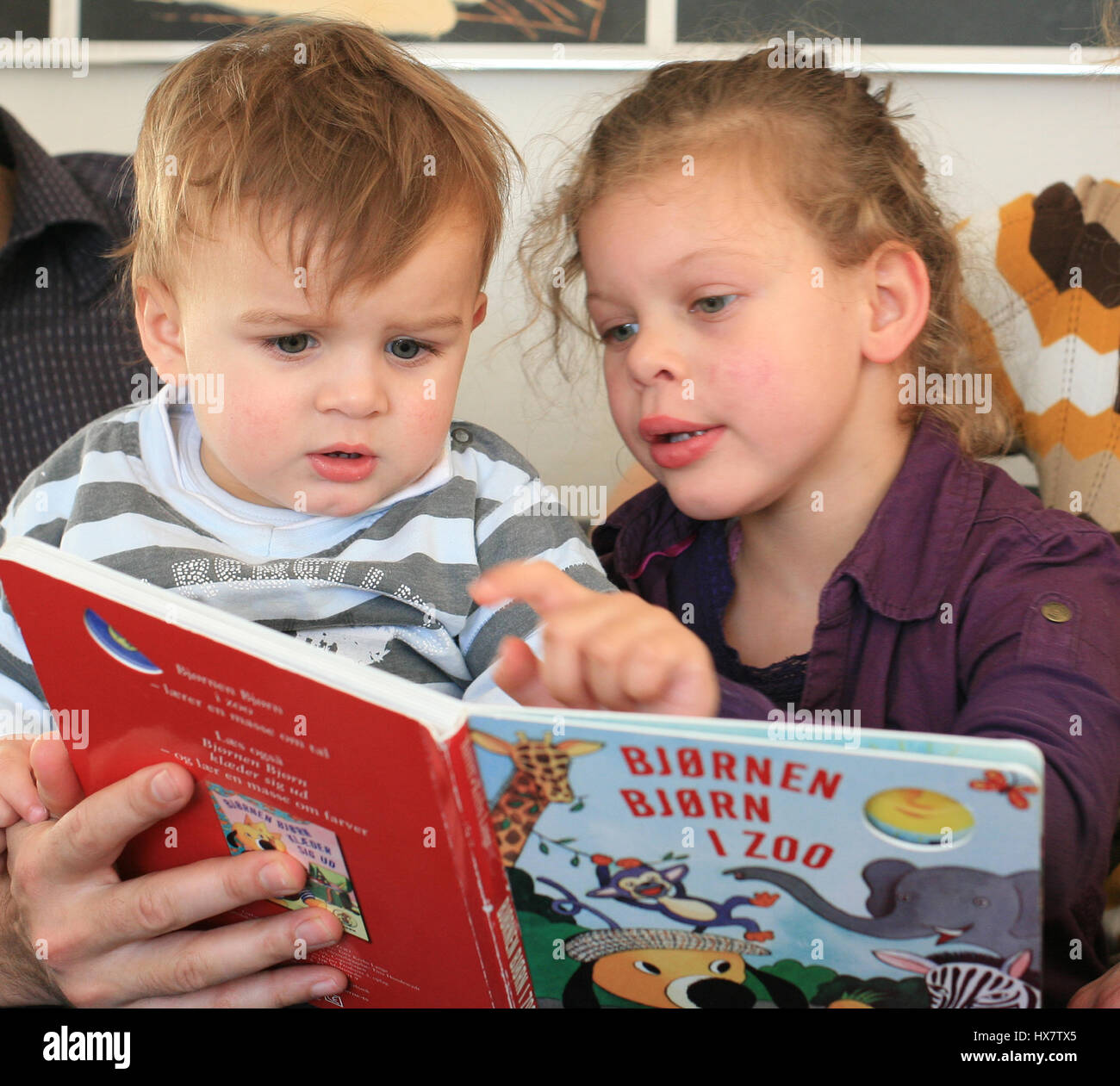 family: brother and sister: reading Stock Photo - Alamy