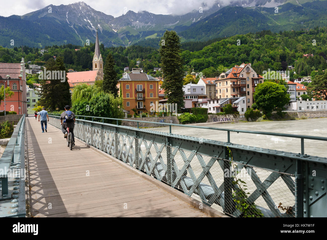 A narrow Pedestrian bridge crossing the river in Innsbruck, Tyrol ...