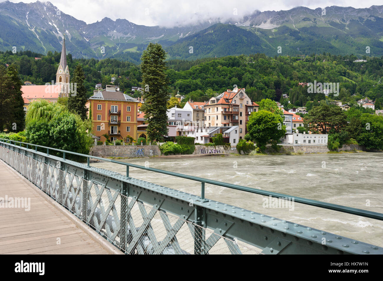 A narrow Pedestrian bridge crossing the river in Innsbruck, Tyrol ...