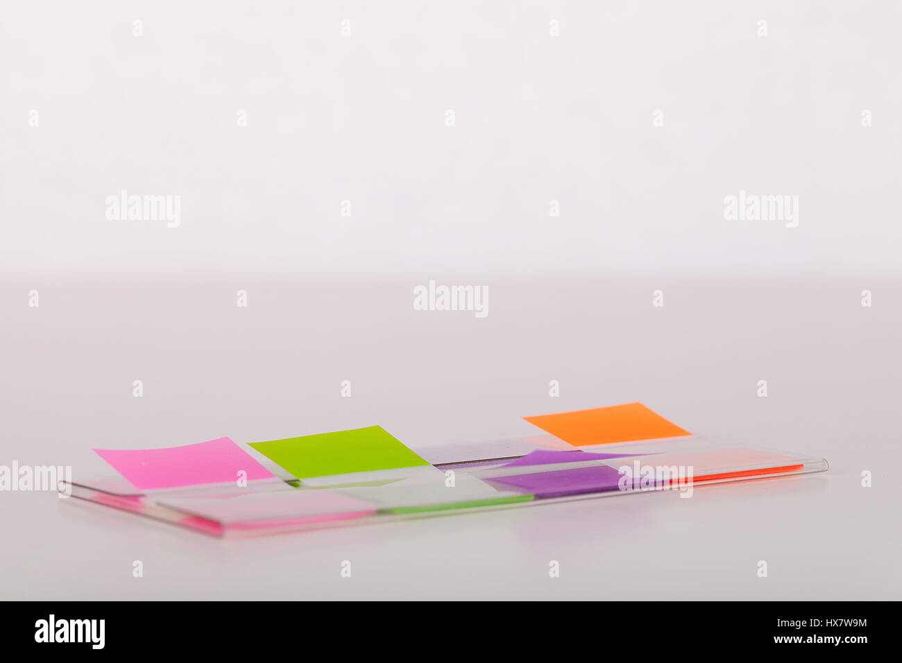 Colorful sticky tabs on a white surface. Post It tabs isolated on white ...