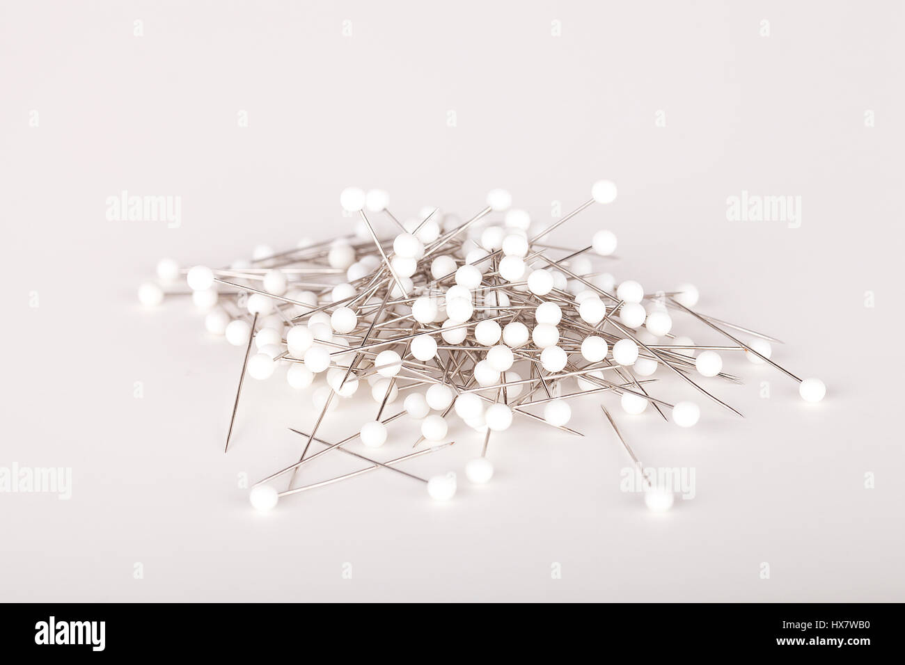 Pile of white straight pins isolated on white background Stock Photo ...