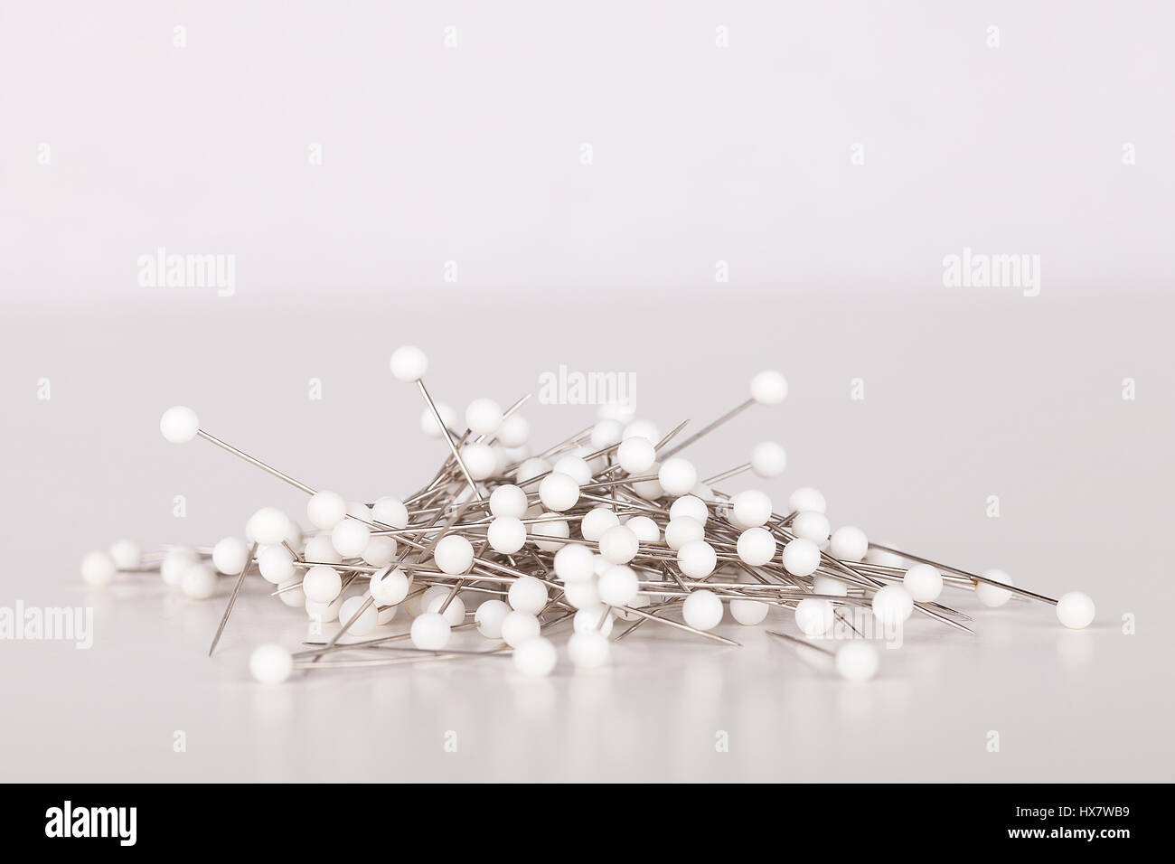 Pile of white straight pins isolated on white background Stock Photo ...