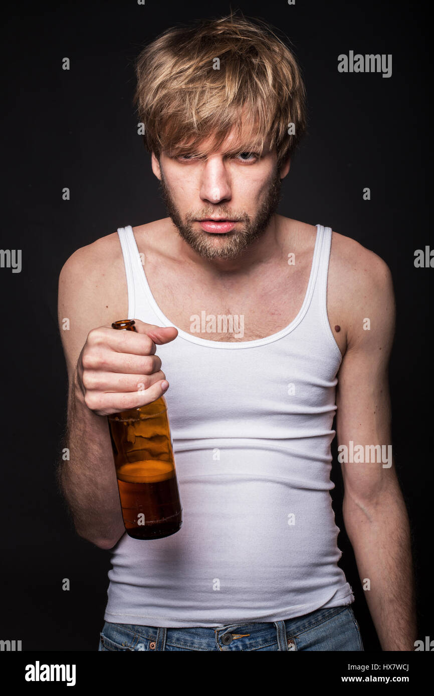 Concept: alcohol addiction. Hangover. After party. Studio portrait over ...