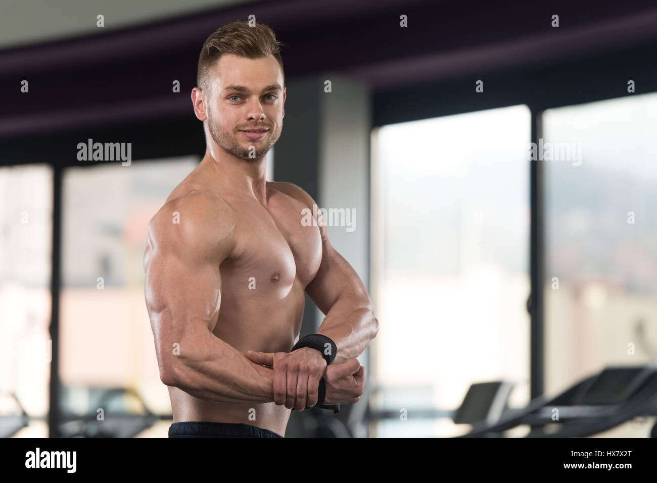 Healthy Man Standing Strong In The Gym And Flexing Muscles - Muscular ...