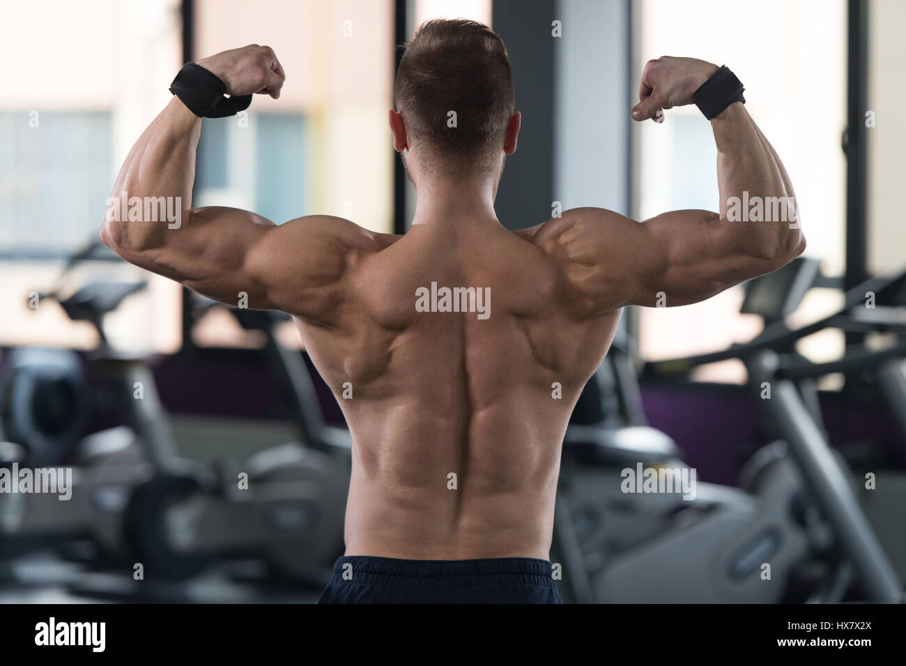 Healthy Man Standing Strong In The Gym And Flexing Muscles - Muscular ...