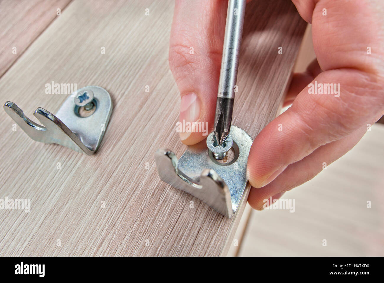 Screw Being Screwed In Wooden Furniture using phillips screwdriver ...