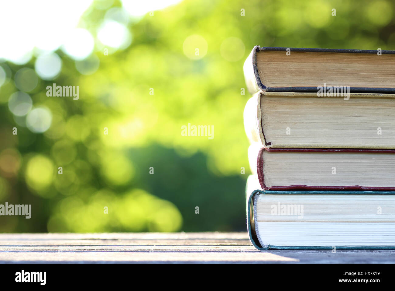 book stack background table wooden outdoor Stock Photo - Alamy