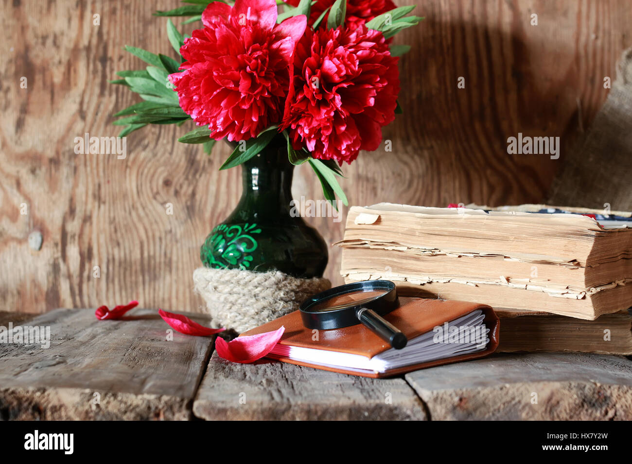 old book flower on wooden table Stock Photo - Alamy