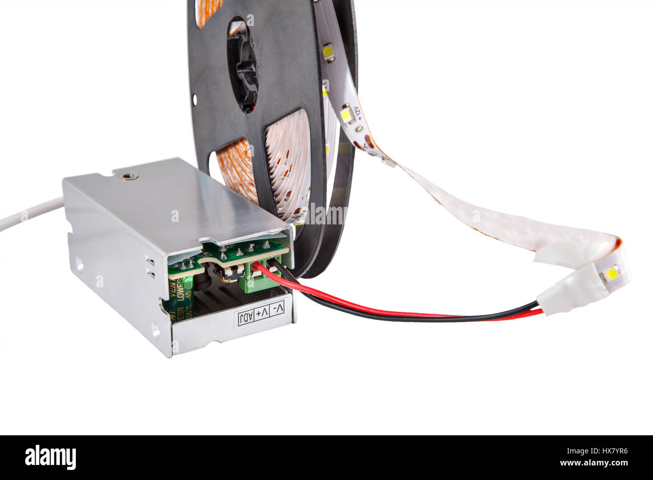 Close-up of LED tape light on the plastic reel, connected to a voltage ...