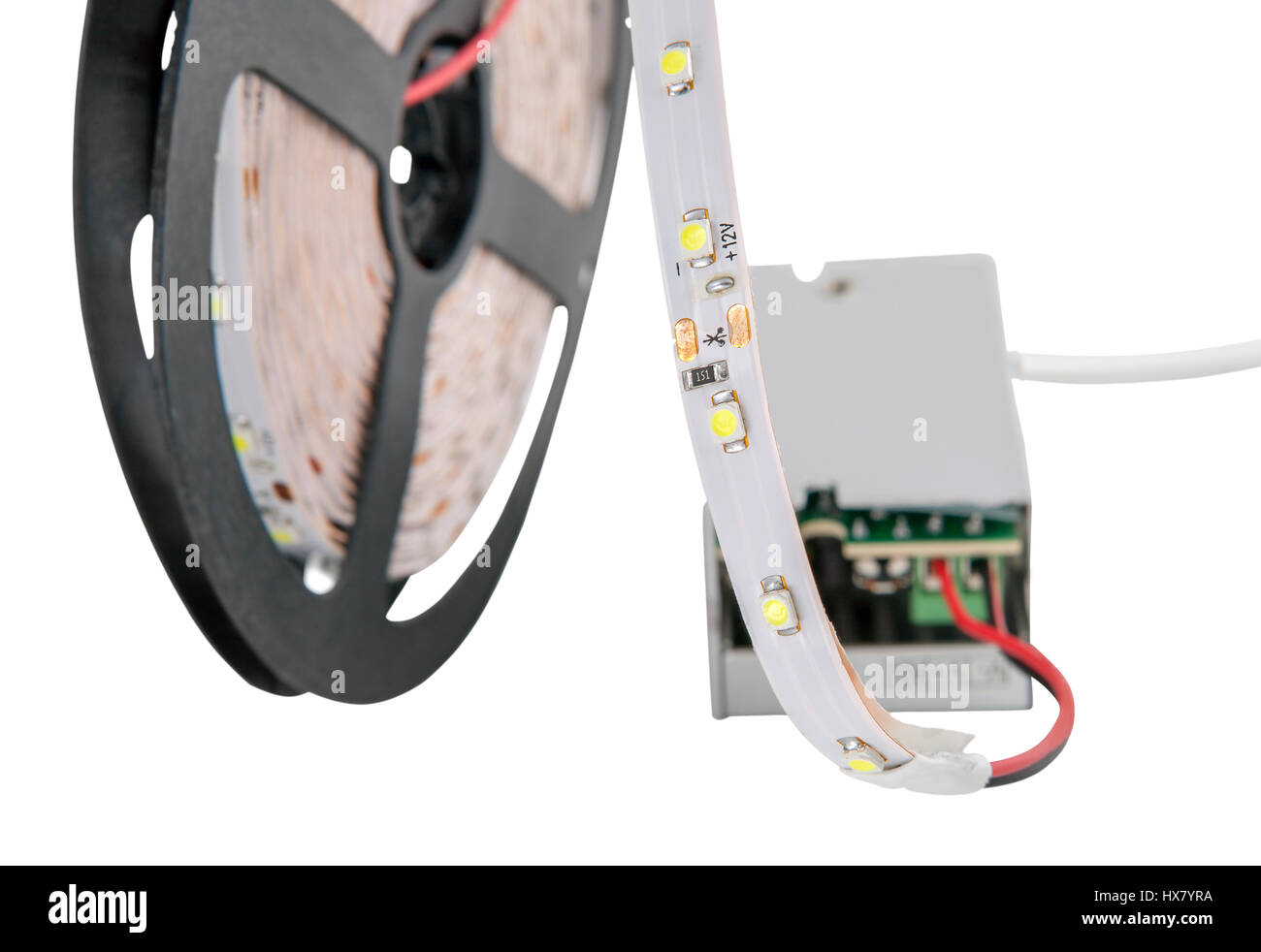 LED strip on the coil connected to the power adapter Stock Photo - Alamy