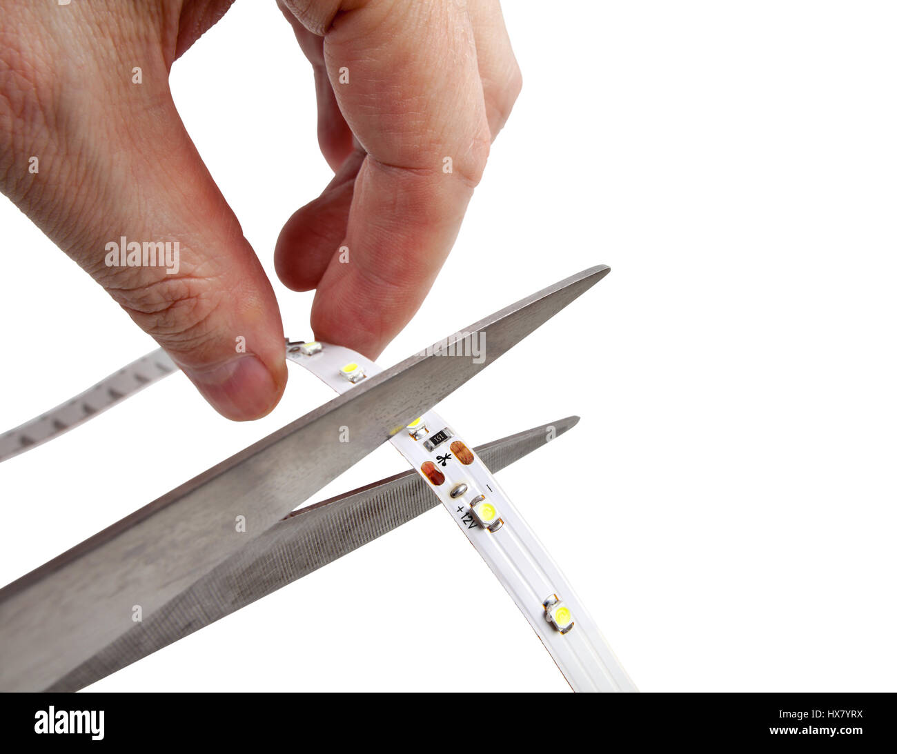 Close-up of hands hold scissors that are cutting LED strip, isolated on ...
