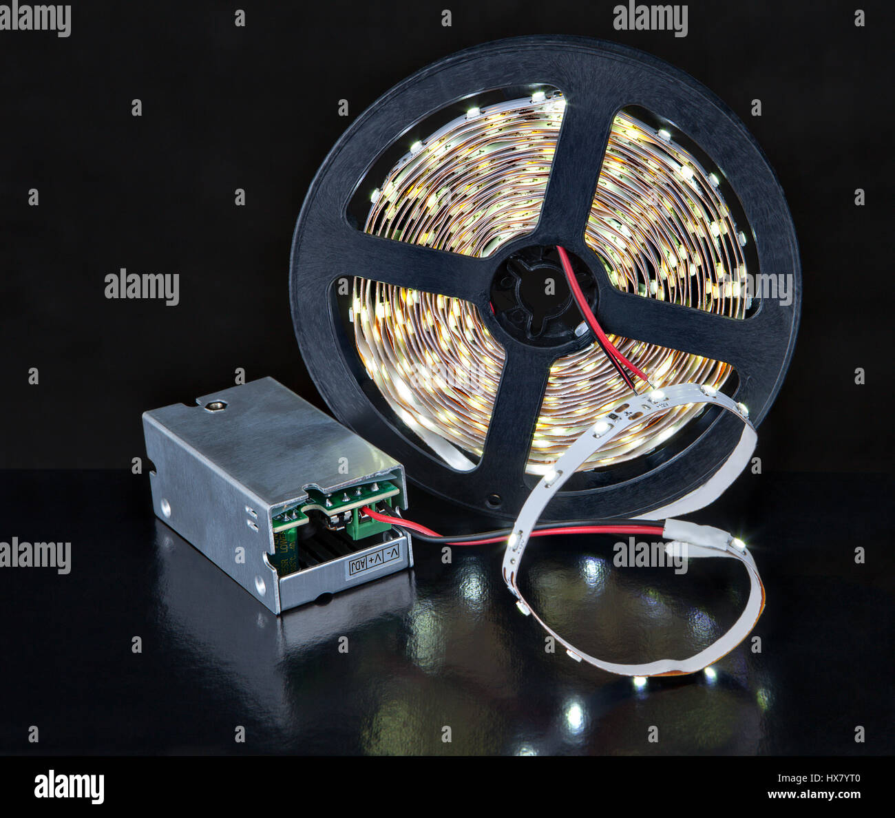 Close-up Shining LED Light Strip on the coil and voltage adapter, on ...