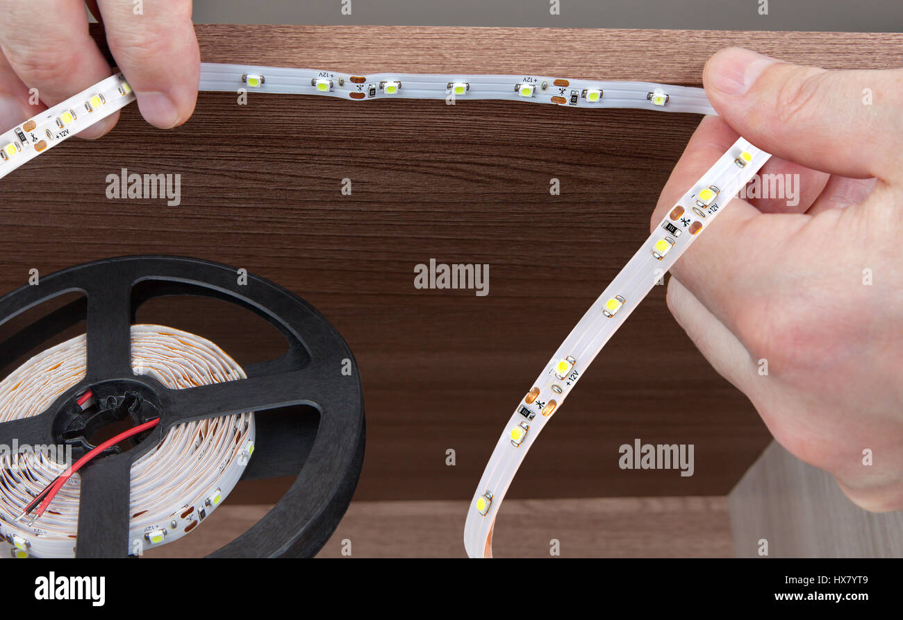 Close-up of the installation of LED lighting inside cabinet Stock Photo ...